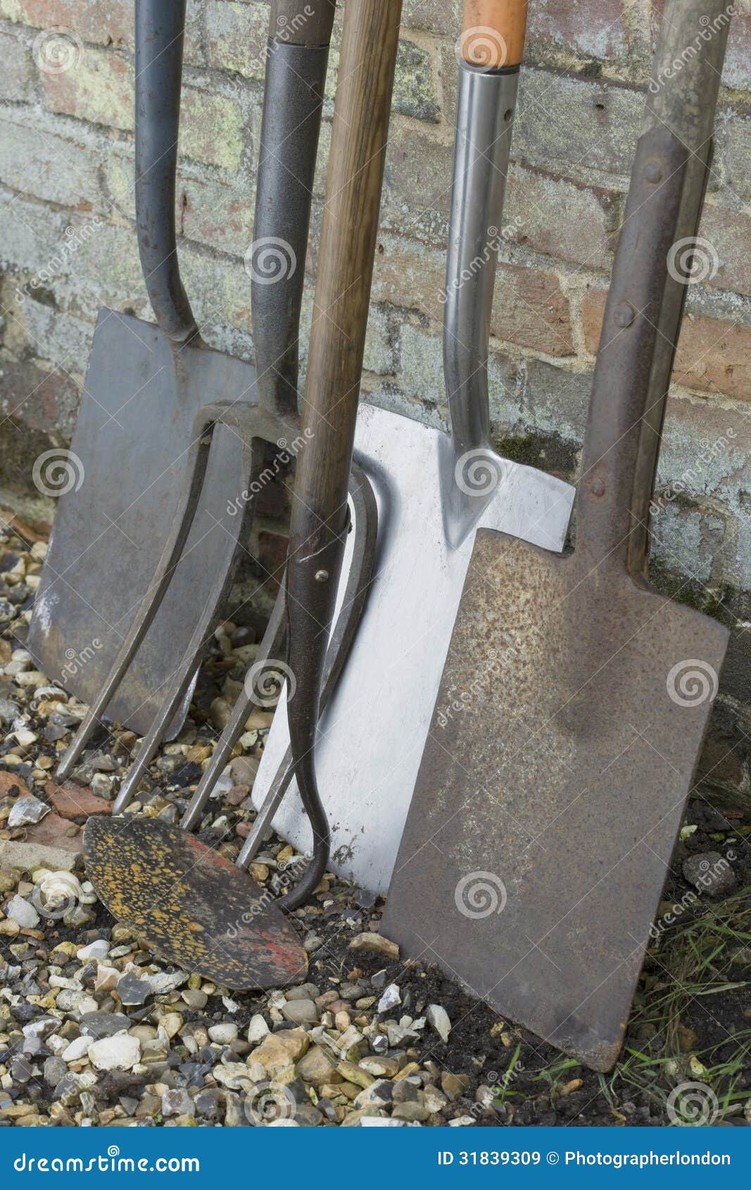 Garden Shovels and Tools Leaning on Brick Wall Stock Image - Image of ...