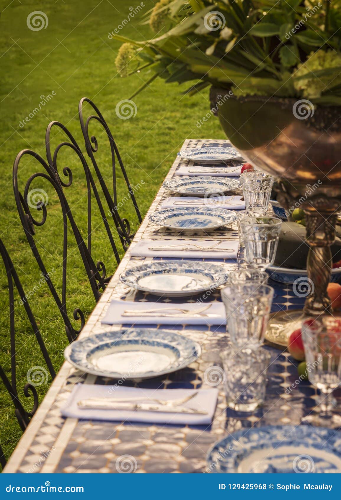 Garden table dinner setup stock photo. Image of catering - 129425968