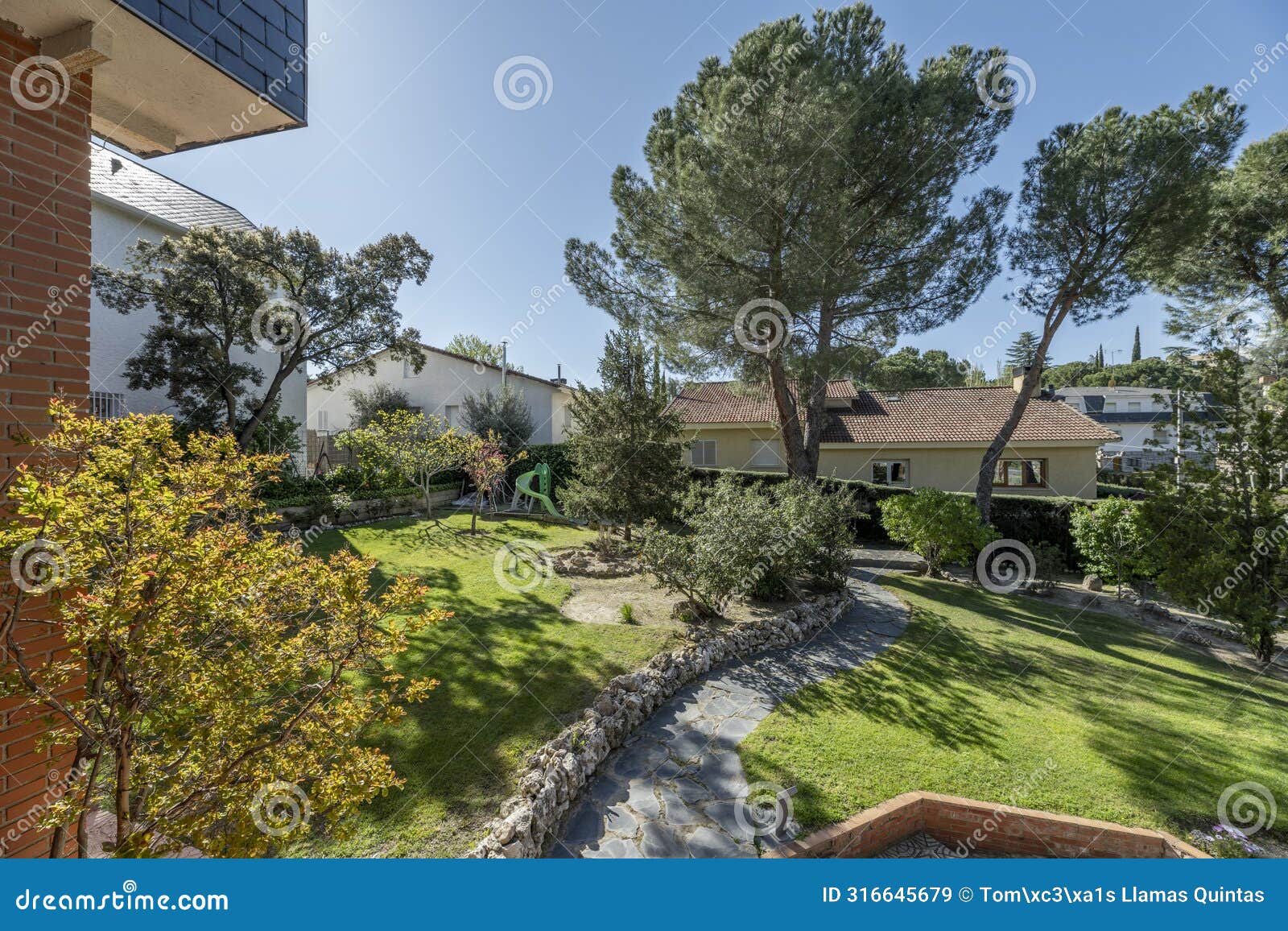 Garden with a Tiled Path and a Grassy Garden in the Background with a ...
