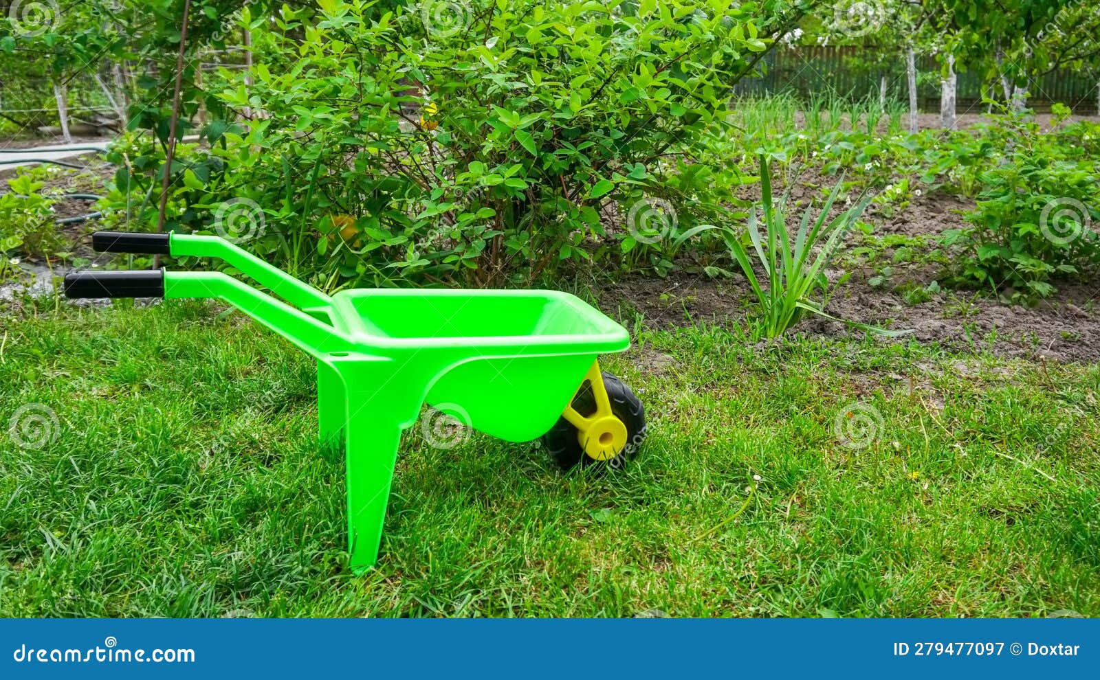 Garden Wheelbarrow. Green Plastic Cart for the Garden Editorial ...