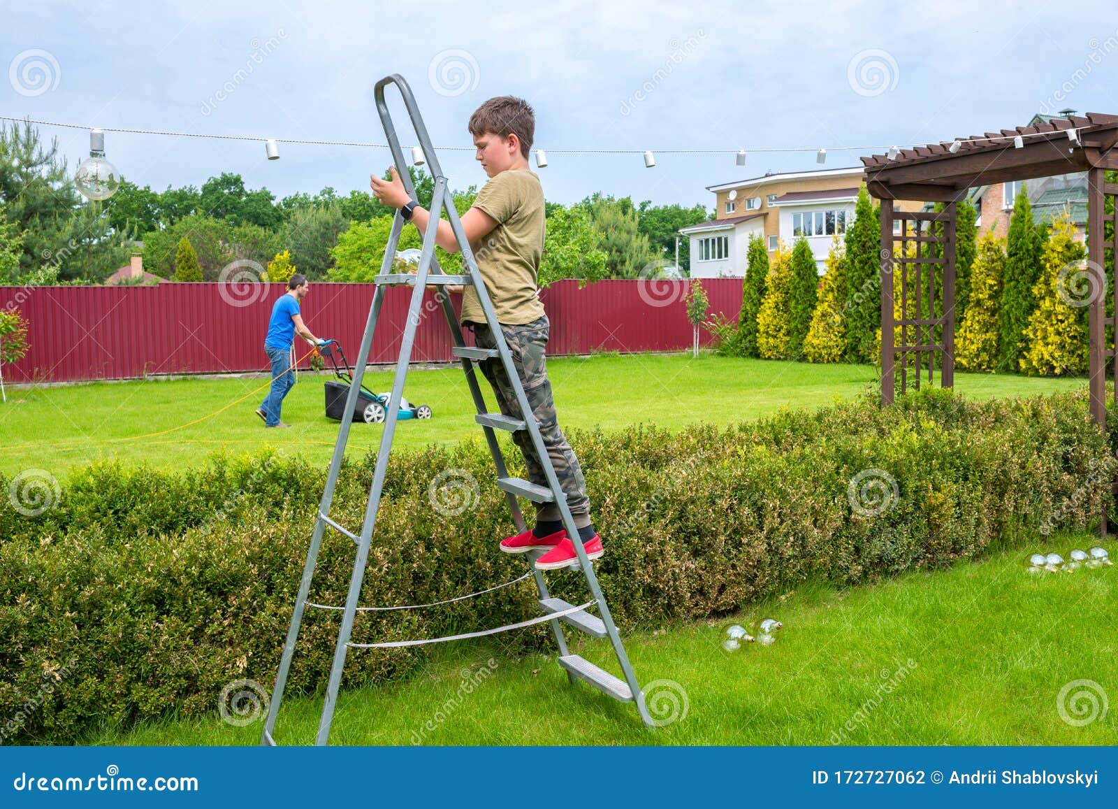 Garden Work. a Boy with His Father are Working in the Backyard Stock ...
