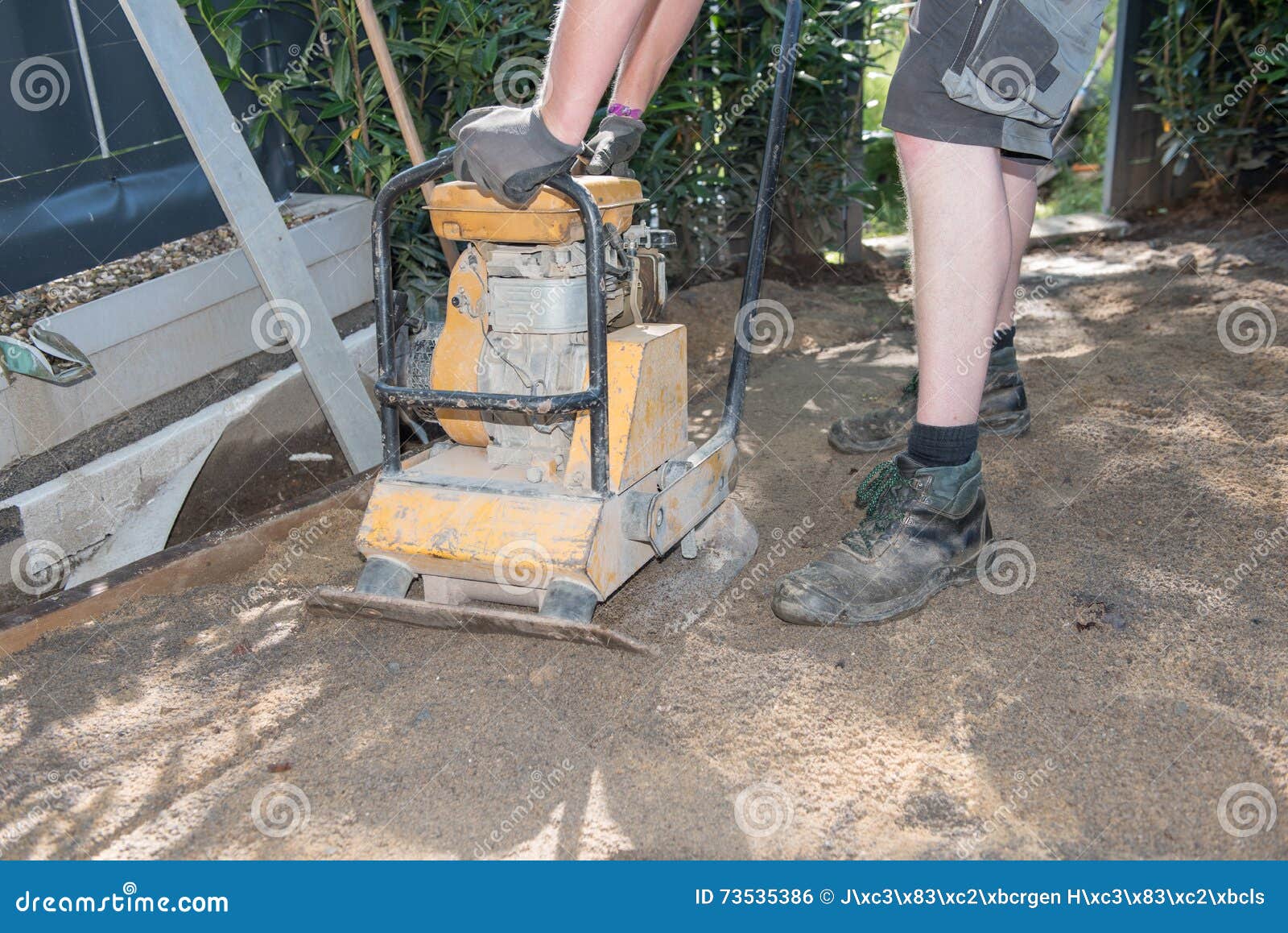 Gardener is Flattening the Ground in the Garden Stock Photo - Image of ...