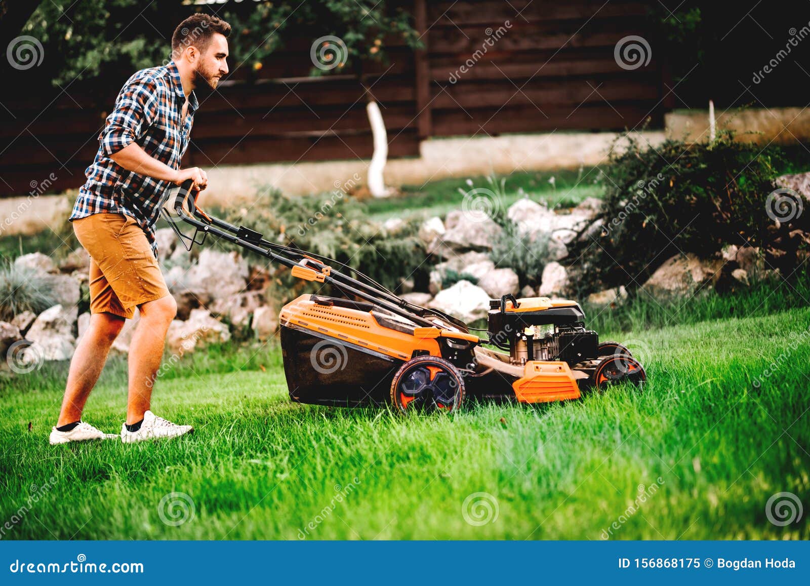 Gardener Mowing the Lawn Using a Professional Lawnmower Stock Image ...