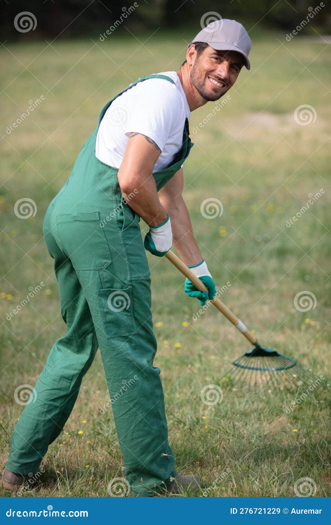 Gardener with rake at work stock image. Image of professional - 276721229