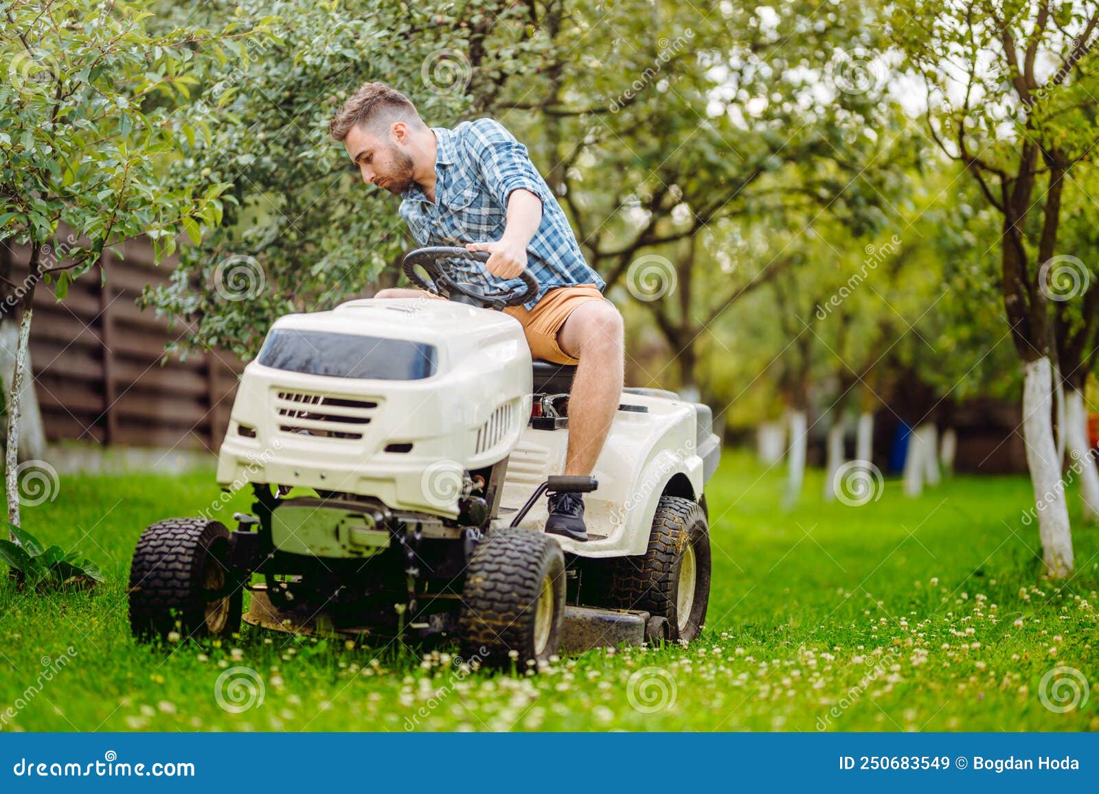 Gardening Works with Handsome Man Using Lawn Mower Stock Image - Image ...