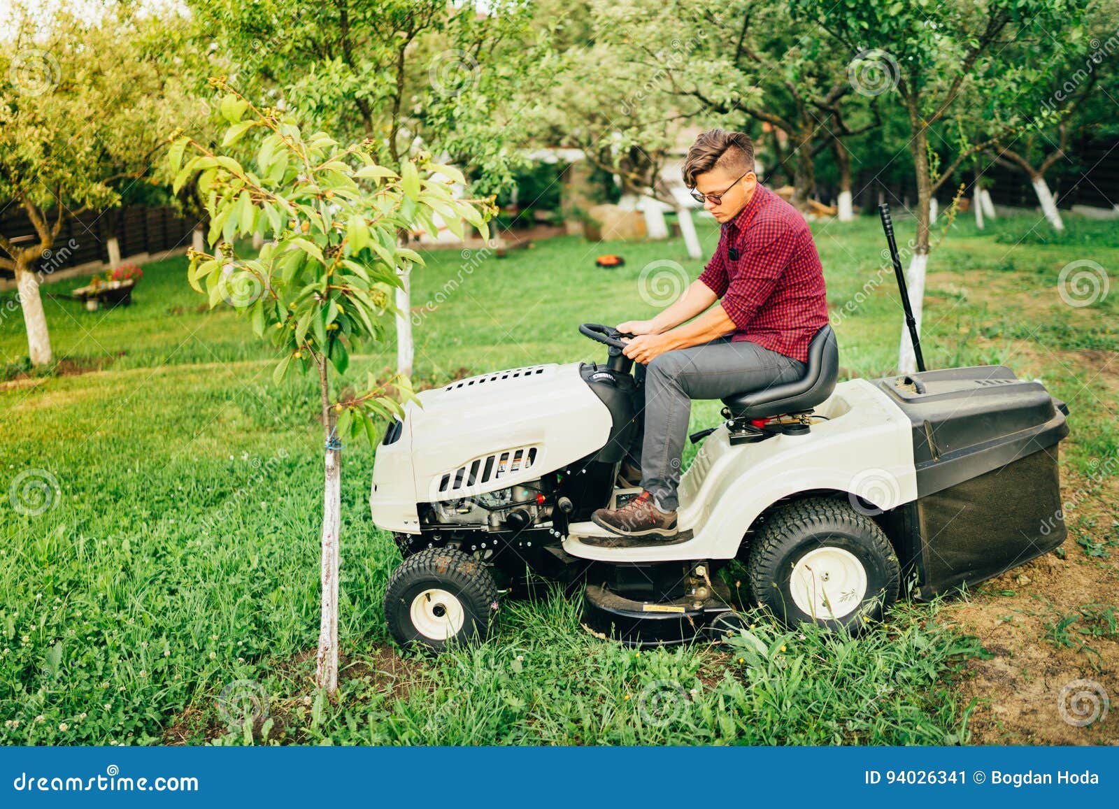 Man Using Lawn Tractor For Mowing Grass. Landscaping Works With ...