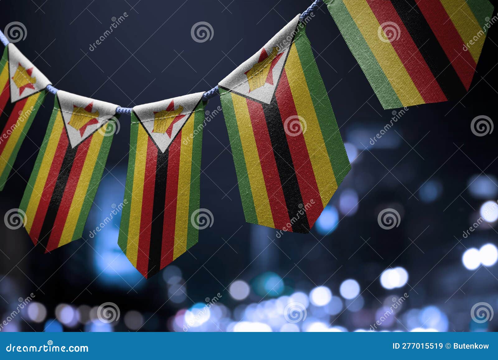 A Garland of Zimbabwe National Flags on an Abstract Blurred Background ...