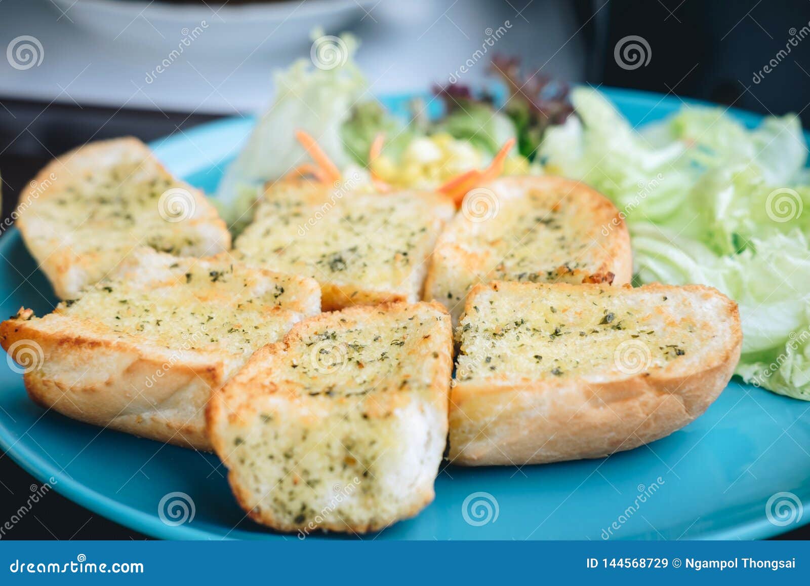 Garlic Bread on the Blue Dish and Vegetable Salad Stock Image - Image ...
