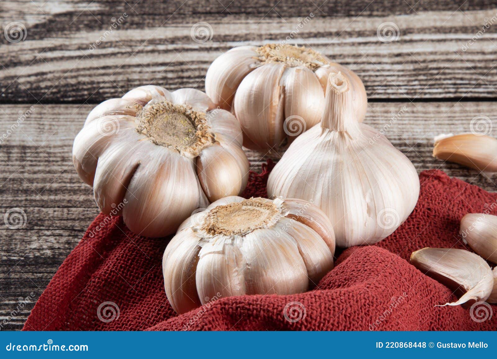 Garlic Cloves and Bulb on Wooden Table and Red Fabric Stock Photo ...