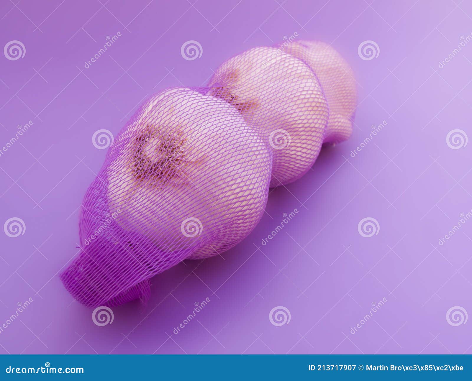 Garlic in Net. Garlic Packaging Nets. Three Garlic Heads Packaged in a ...