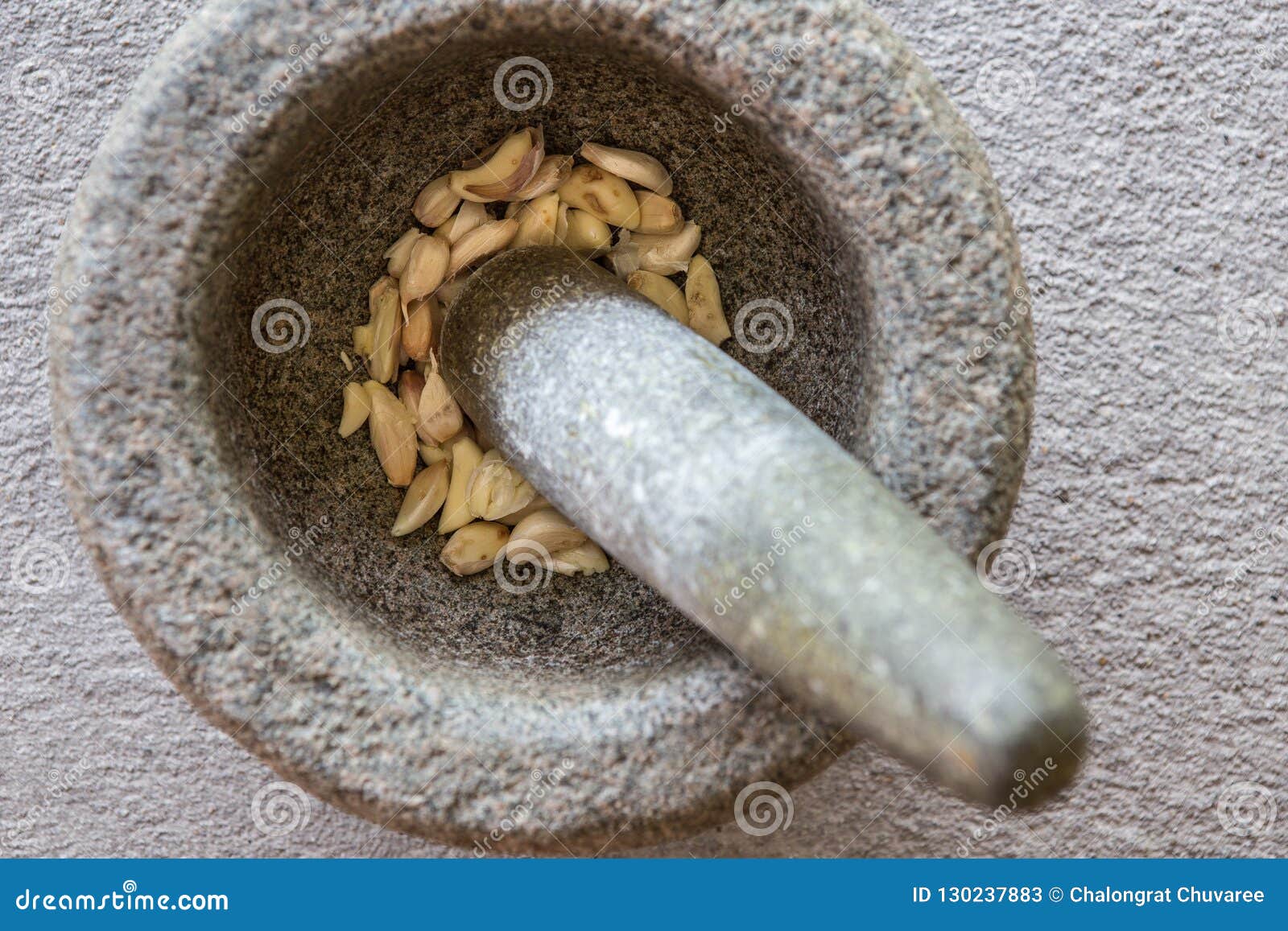 Garlic in stone mortar stock image. Image of aromatic - 130237883