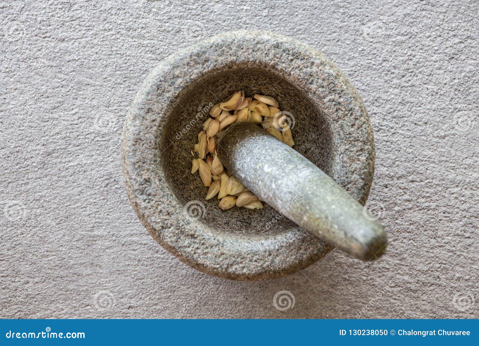 Garlic in stone mortar stock photo. Image of grinder - 130238050
