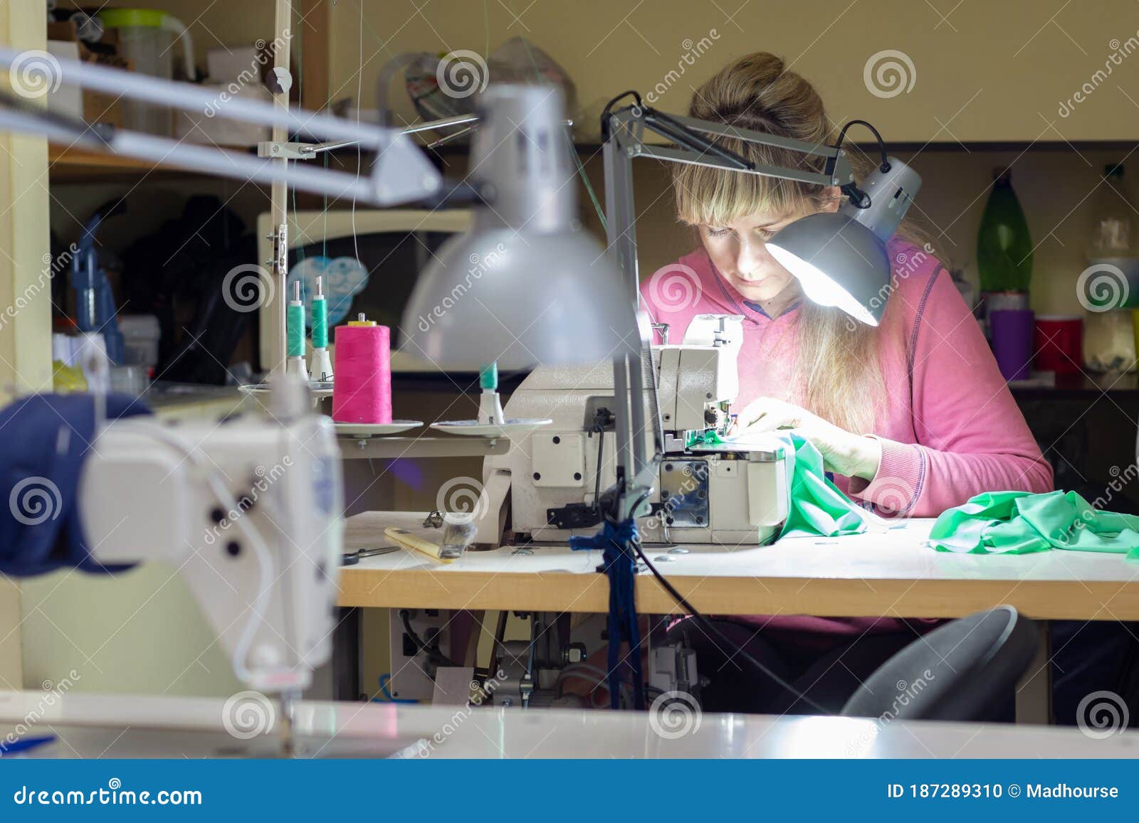 Garment Worker at the Work Desk by the Light of the Lamp Stock Photo ...
