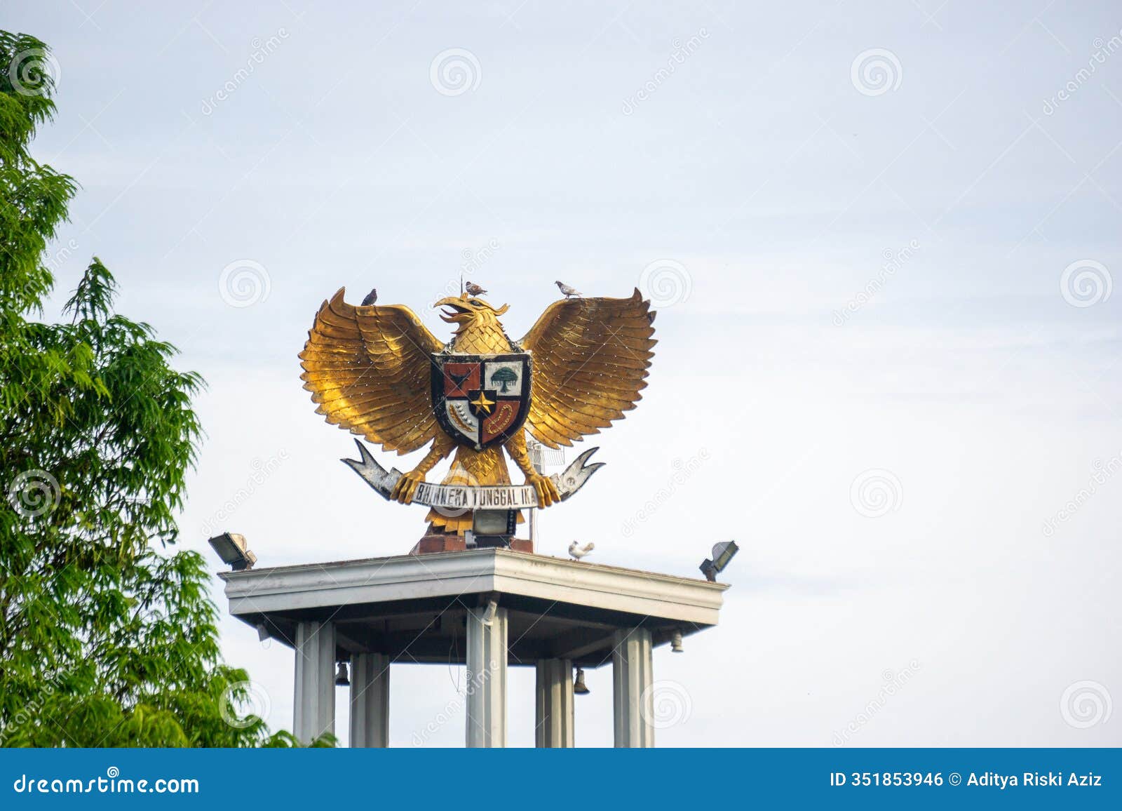 Gold Garuda Pancasila, Indonesian National Emblem On Blue And Cloudy ...