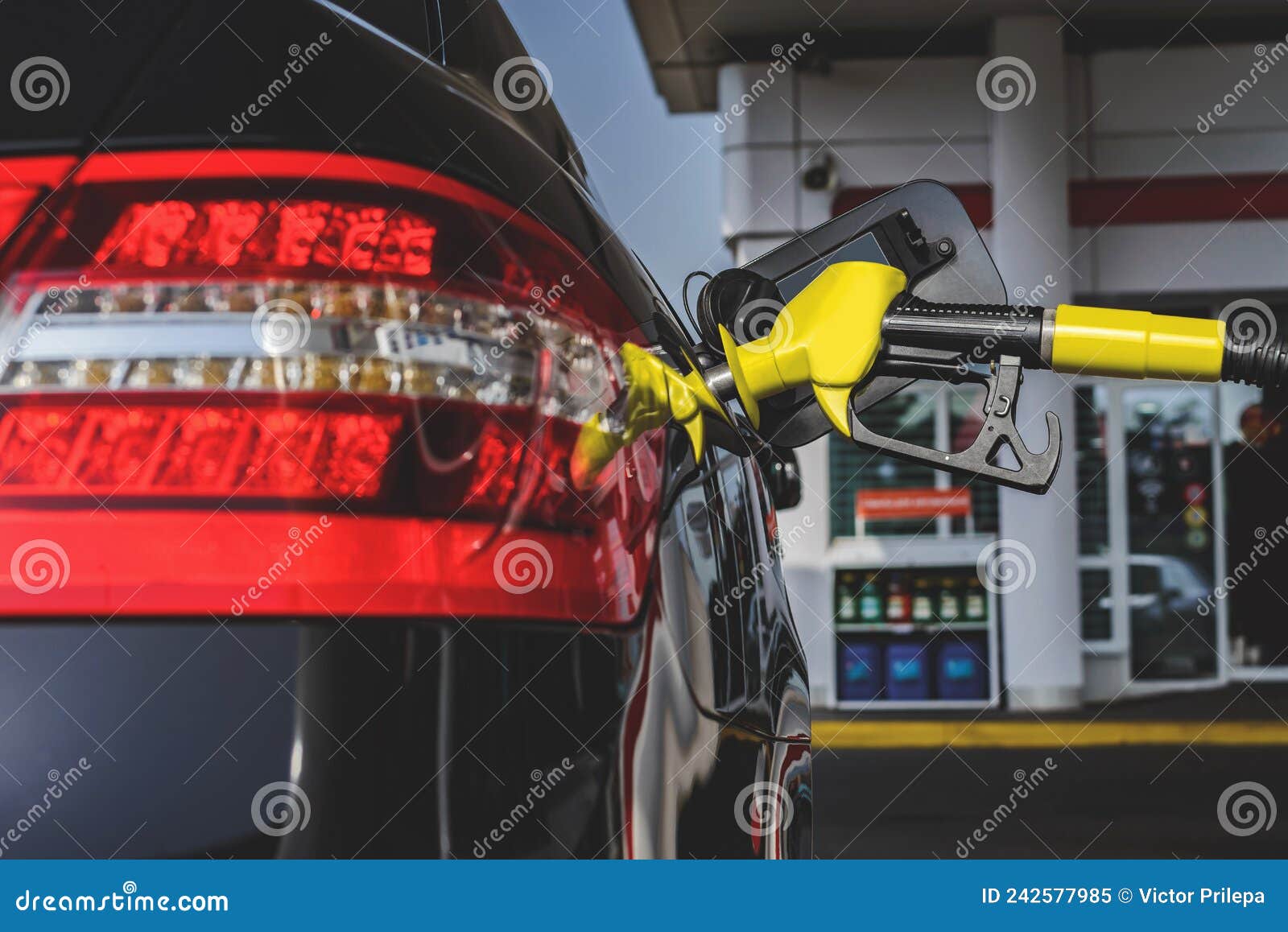 The Gas Station Gun is Inserted into the Gas Tank for Refueling. Close ...