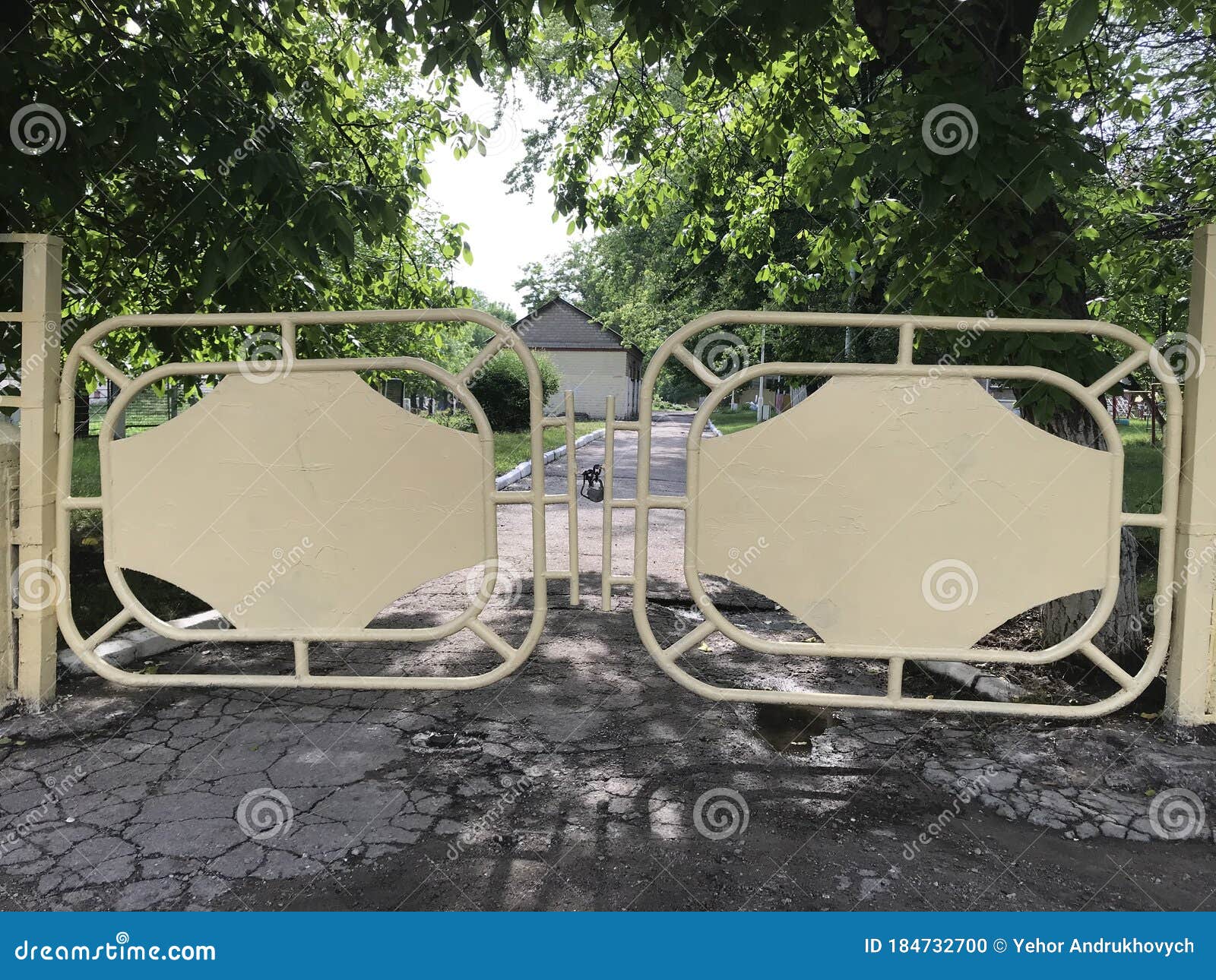 Gates with a Yellow Driveway Lock Stock Photo - Image of gates, locked ...