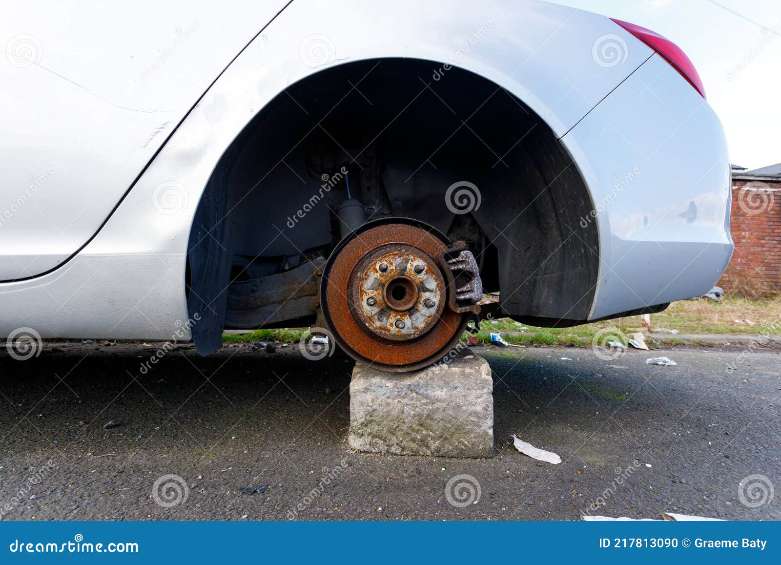 A Broken Down Car with Wheels Removed on Bricks Stock Photo - Image of ...