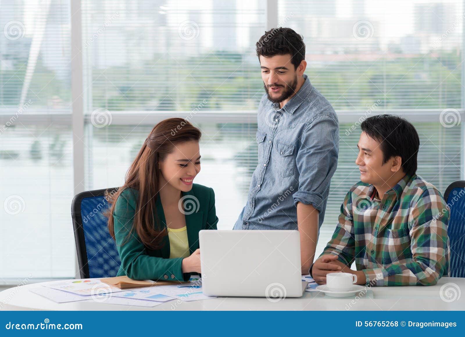 Gathered around laptop stock photo. Image of business - 56765268