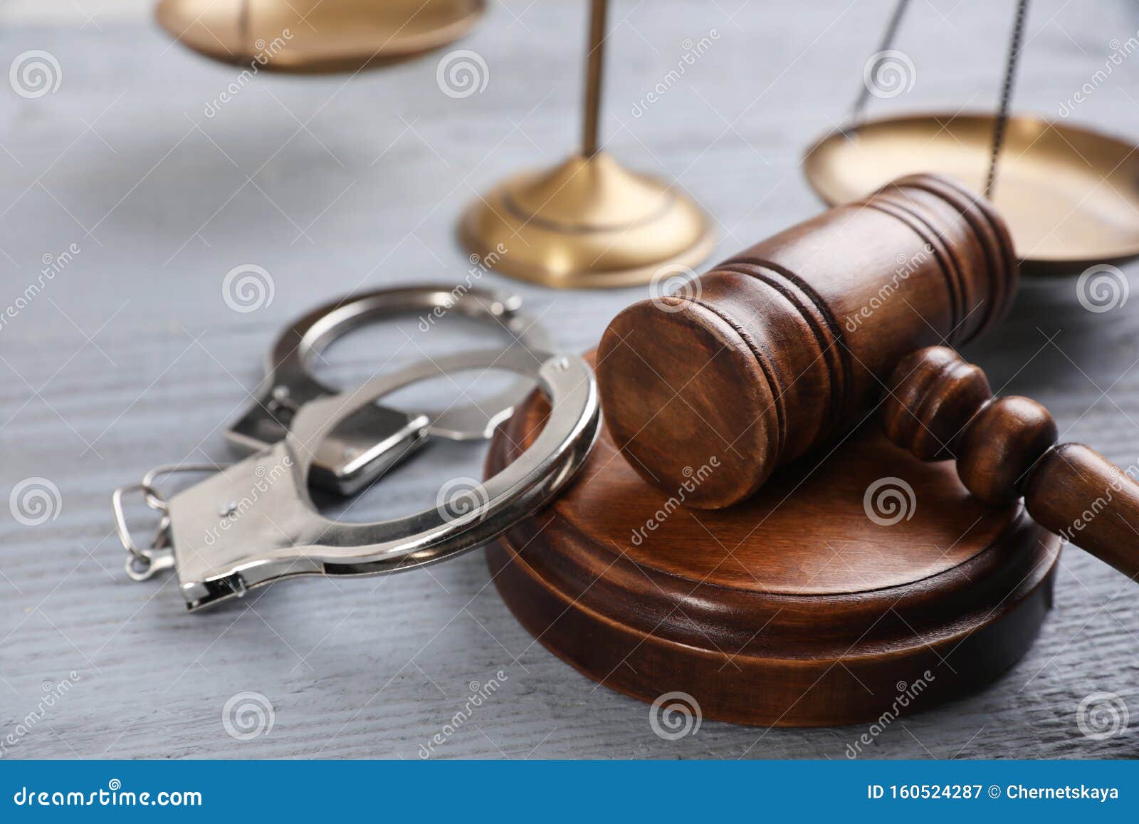 Gavel, Handcuffs and Scales of Justice on Grey Wooden Table. Criminal ... Gavel, Handcuffs and Scales of Justice on Grey Wooden Table. Criminal ...