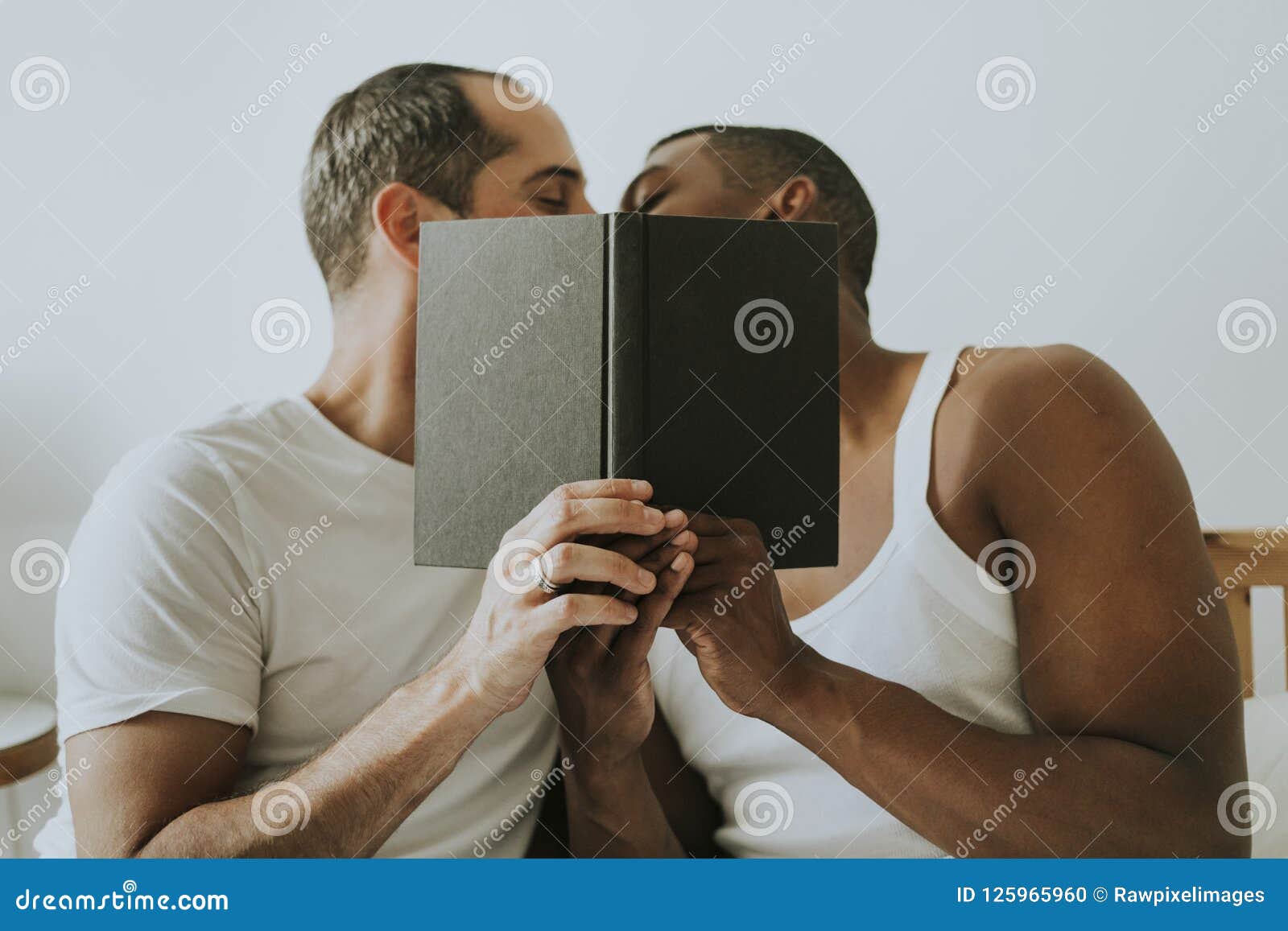 Gay couple cuddling in bed stock photo. Image of cuddling - 125965960