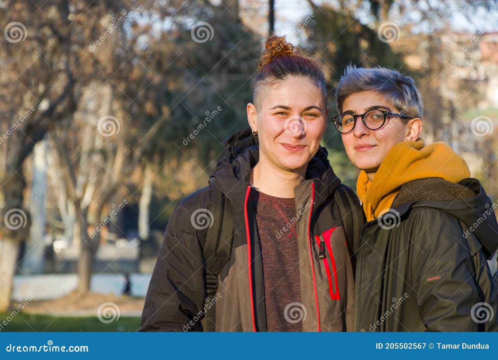 Gay Lesbian Couple Portrait Two Adult Woman In The Park Smiling And