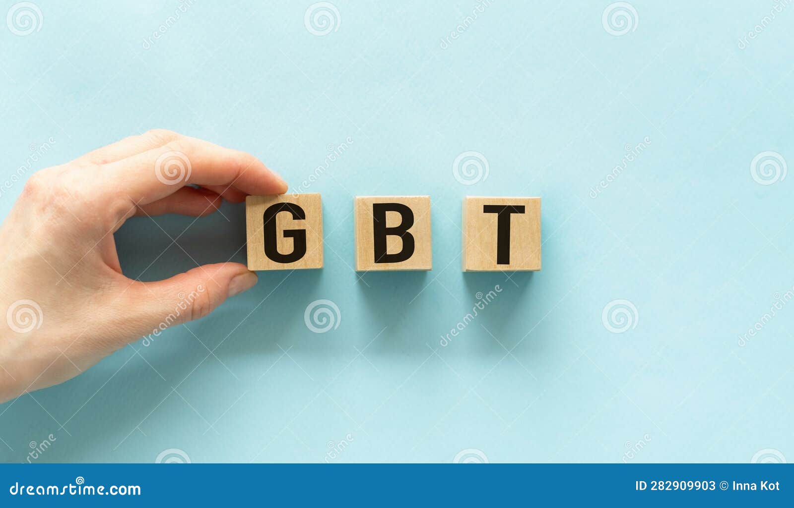 GBT Text on Wooden Block and Hand on Blue Background Stock Image ...