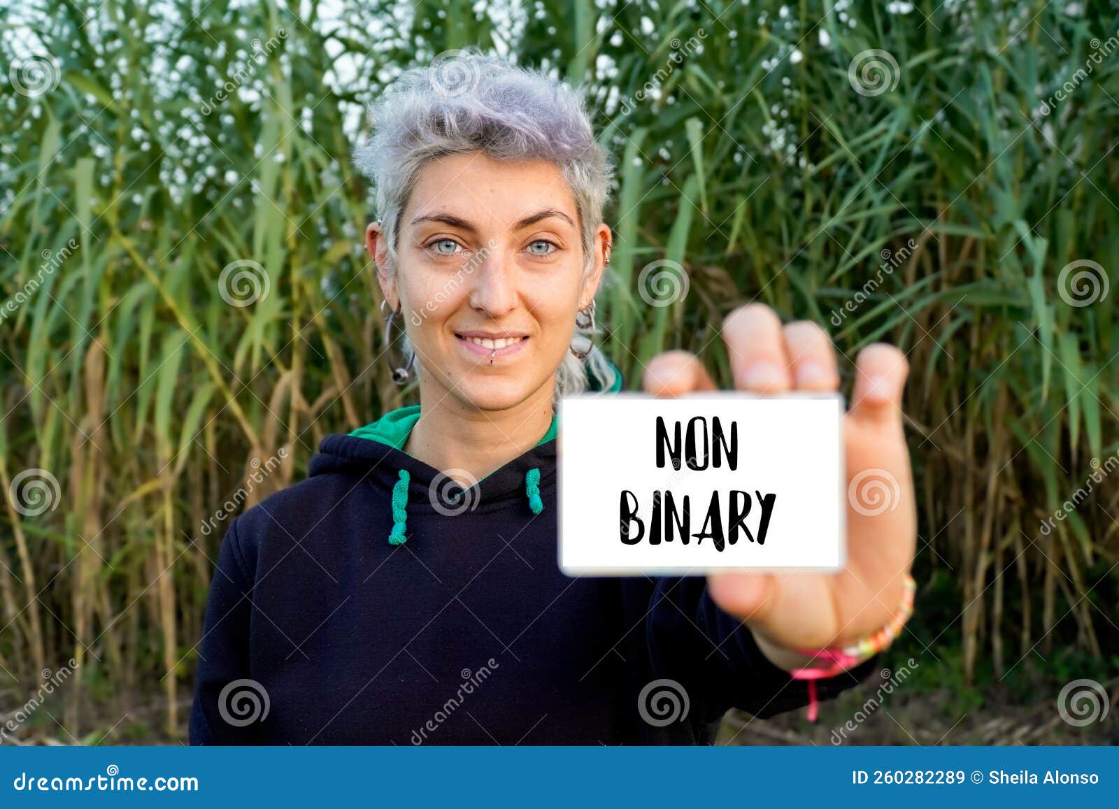 Gender Identity. Person with a Non Binary Cartel Looking at Camera ... Gender Identity. Person with a Non Binary Cartel Looking at Camera ...