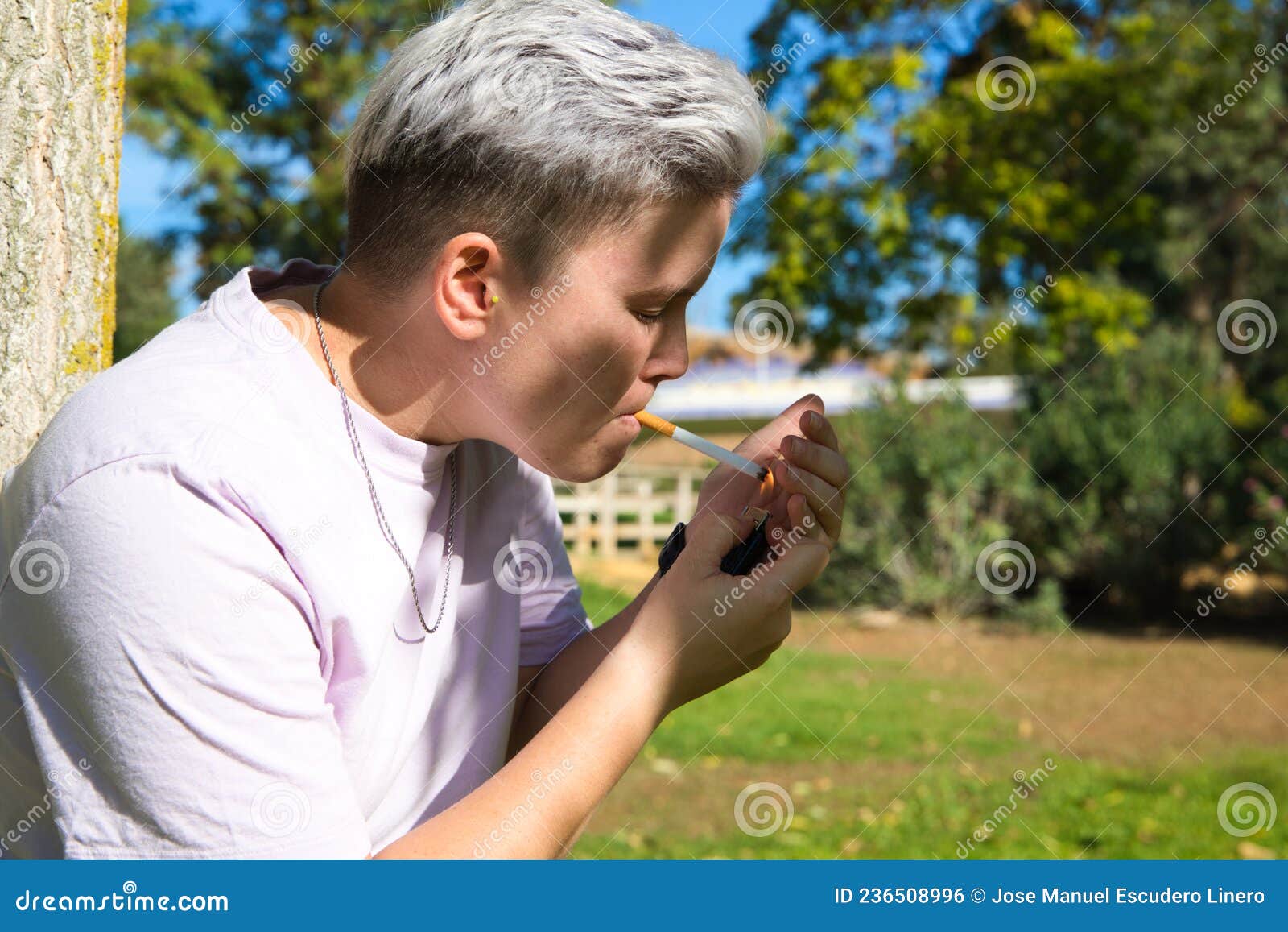 Gender Non-binary and Androgynous Person is Leaning Against a Tree ...