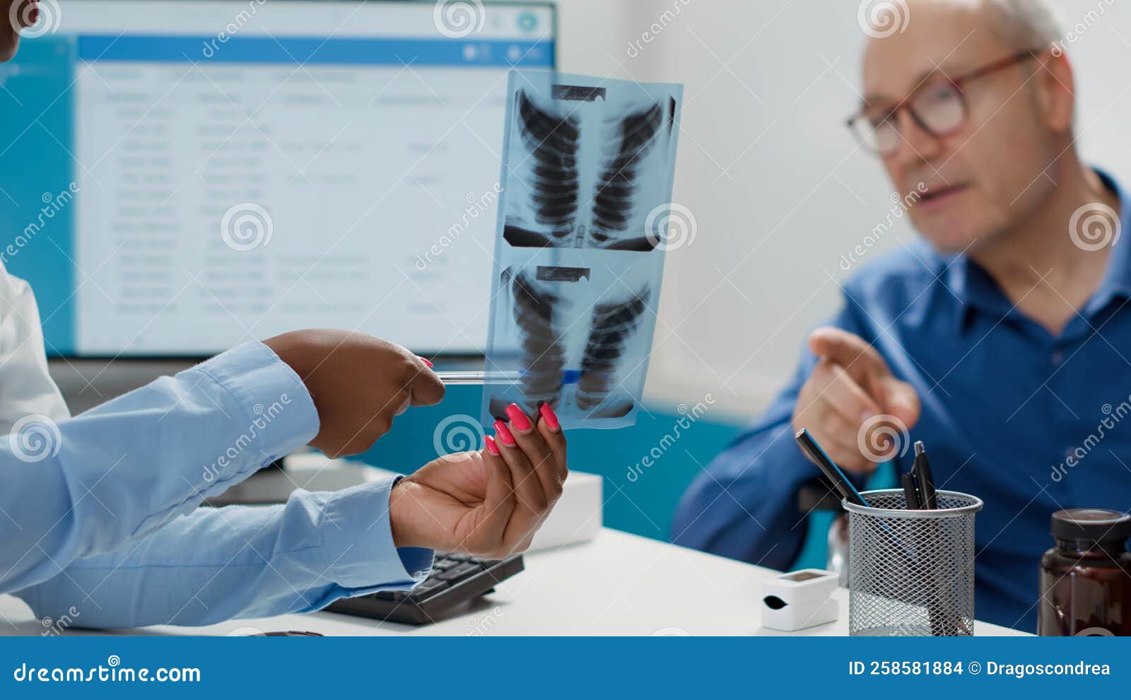 General Practitioner Analyzing X Ray Scan with Senior Man Stock Photo ...