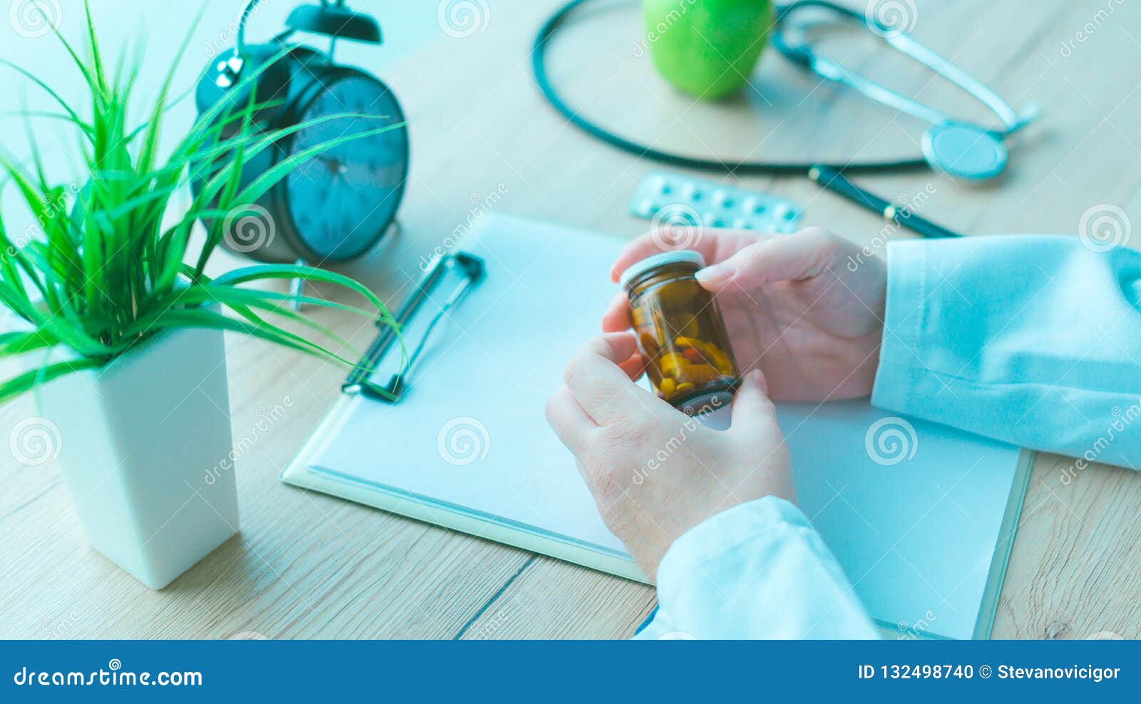 General Practitioner Holding Unlabeled Bottle of Various Pills a Stock ...