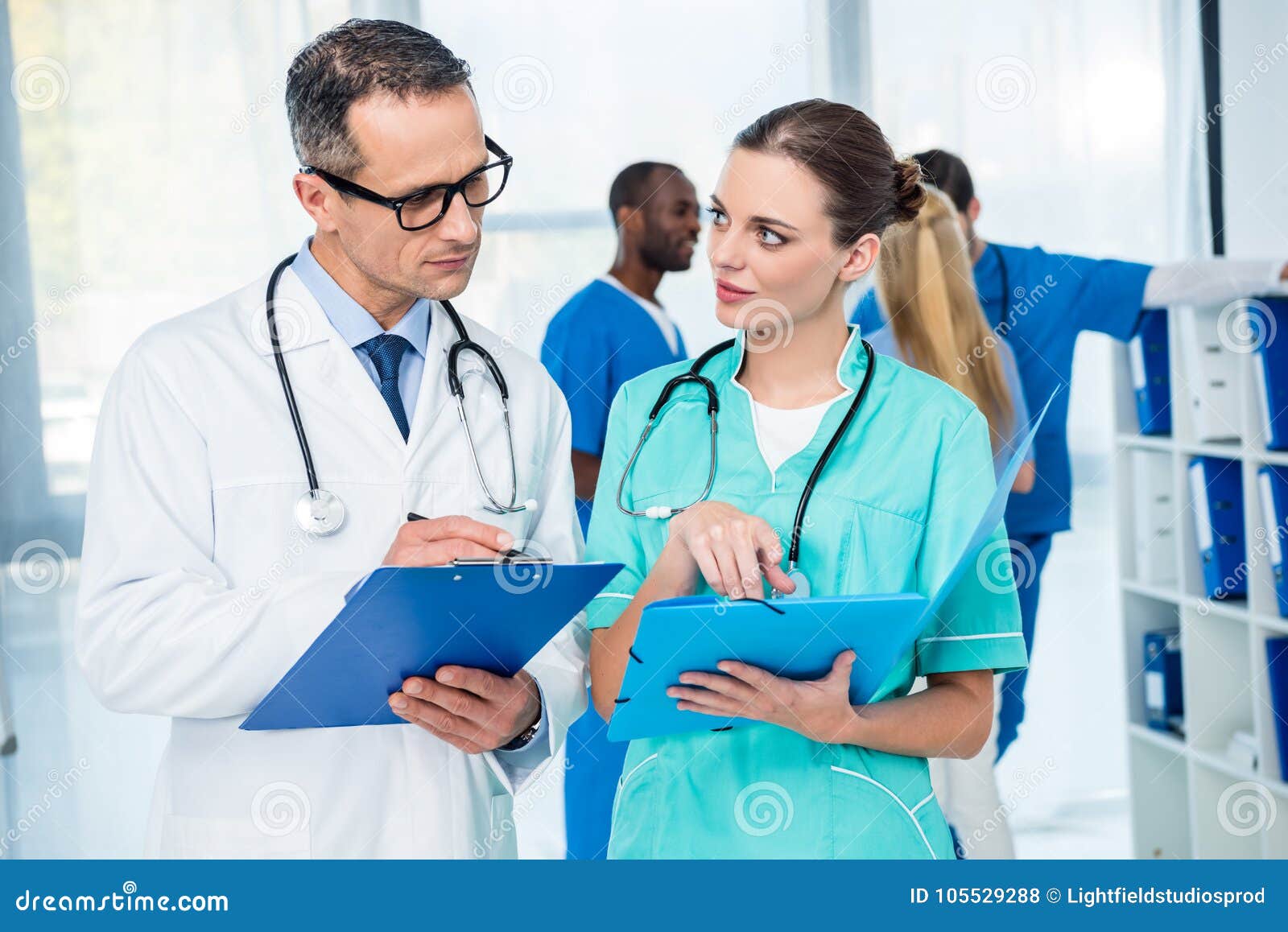 Doctors Doing Paperwork Together Stock Photo - Image of safety, safe ...