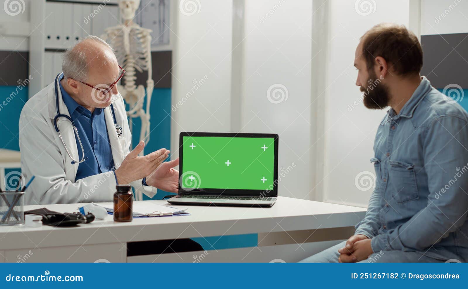 General Practitioner Pointing at Laptop Display with Greenscreen Stock ...