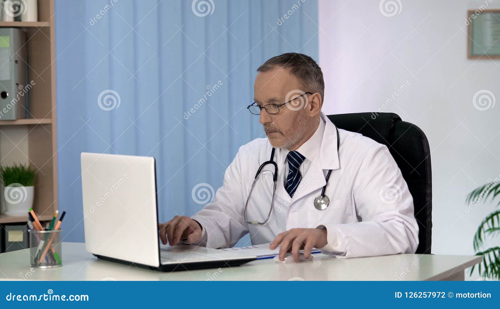 General Practitioner Putting Patient Data in Electronic Medical Record ...
