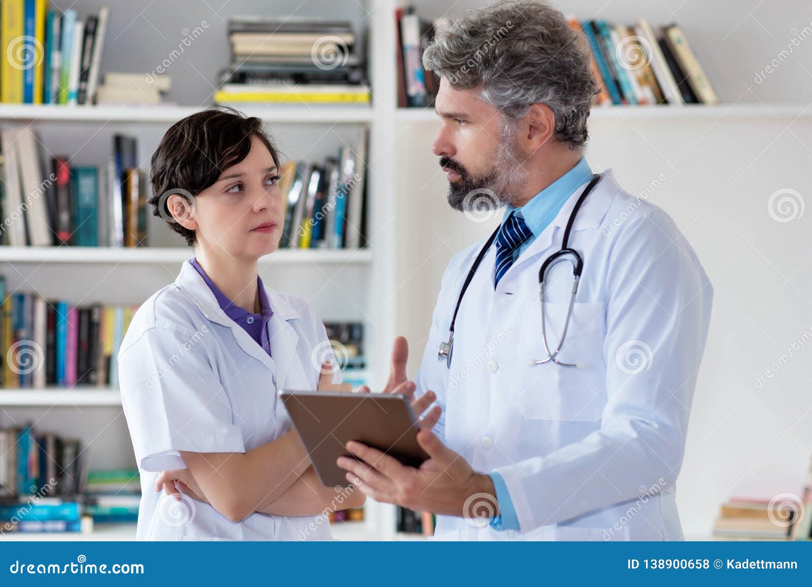 General Practitioner Talking with Nurse about Therapy of Patient Stock ...