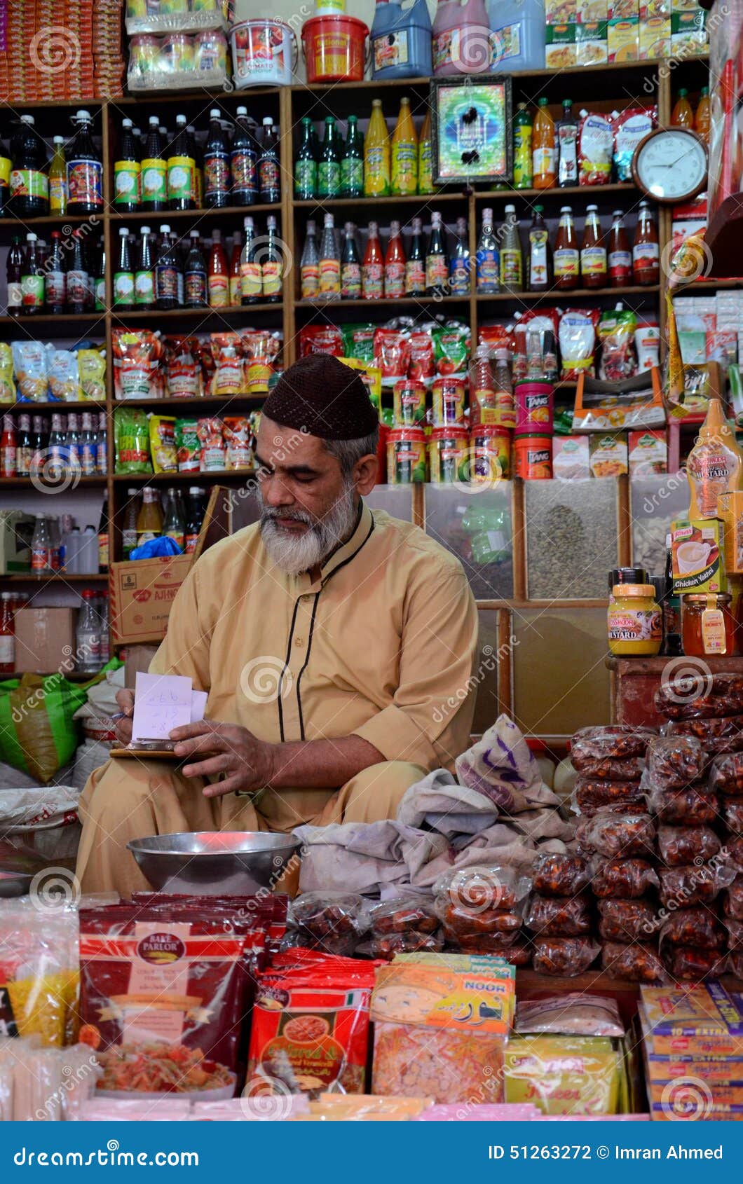 General Store Keeper Tends To Paperwork at Empress Market Karachi ... General Store Keeper Tends To Paperwork at Empress Market Karachi ...