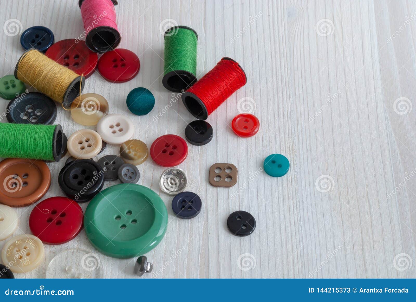 General Top View of Spools of Thread and Buttons on White Wooden ...