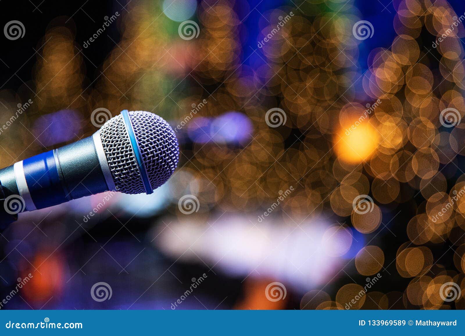 Microphone on Stage with Golden Lights in Background Stock Image ...