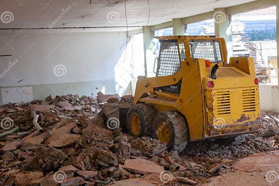 A Compact Bulldozer Clears Rubble at a Renovation Site, Showcasing Its ...