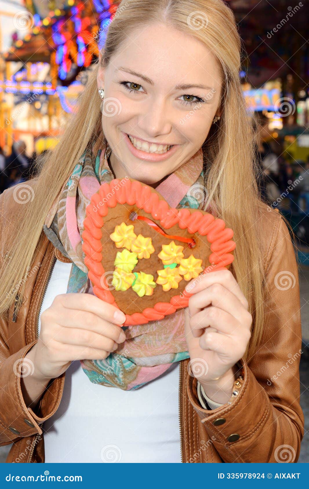 Happy Woman Visits a Fun Fair and Holds a Gingerbread Heart with Candy ...