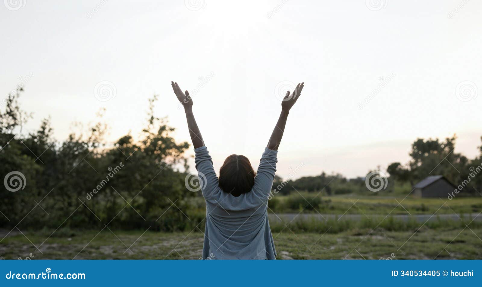 Praising the Lord. a Woman with Her Arms Raised To the Sky in ...