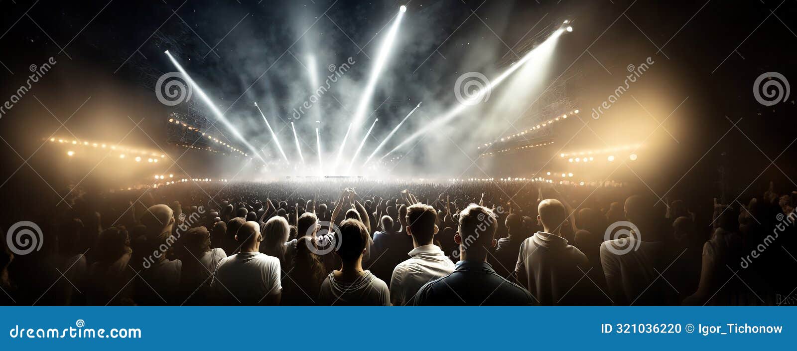 A Large Crowd Enjoying a Concert with Spectacular Lighting Effects and ...