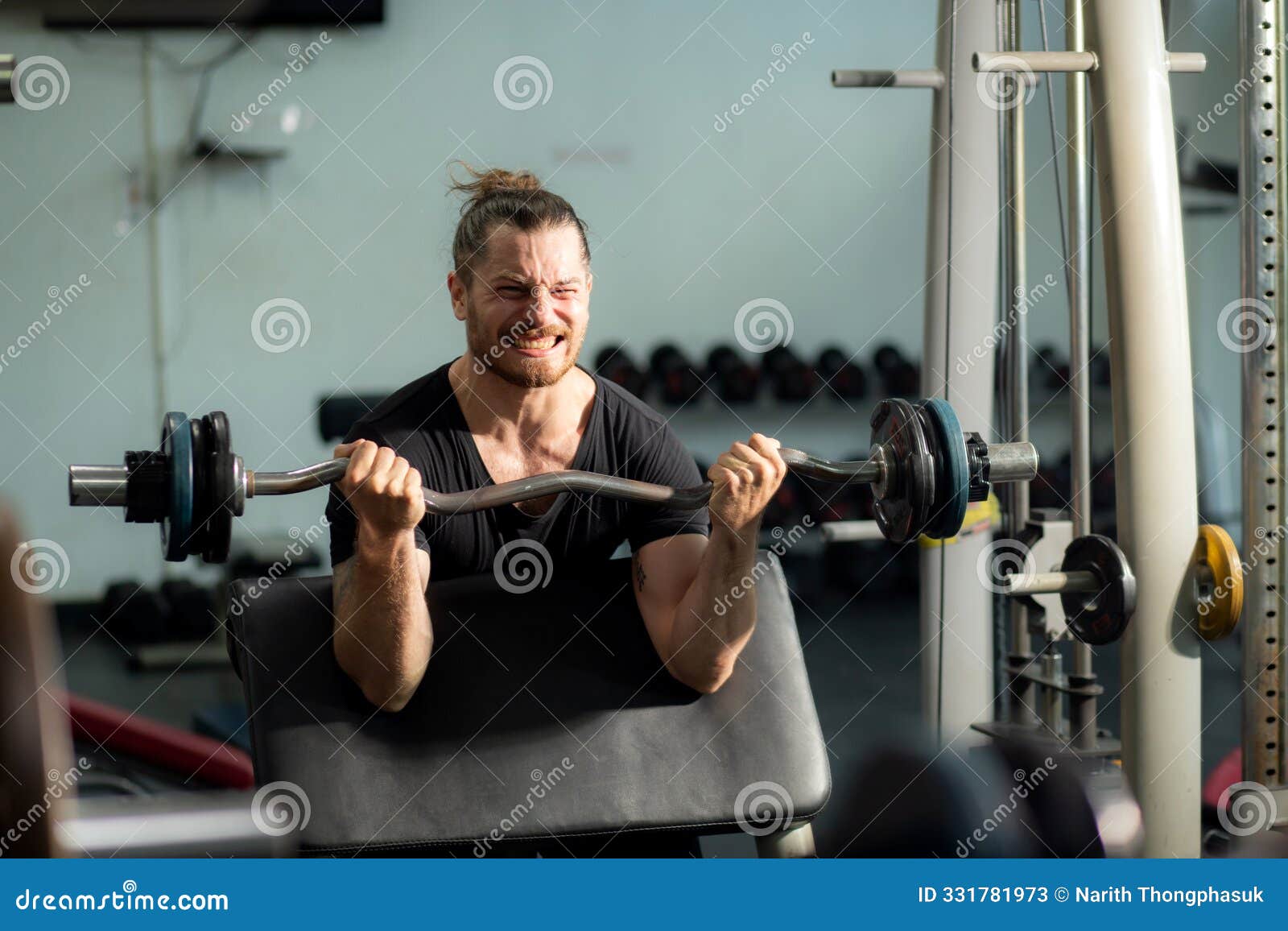 Man Working Out in a Gym, Lifting Weights with a Focused and Intense ...