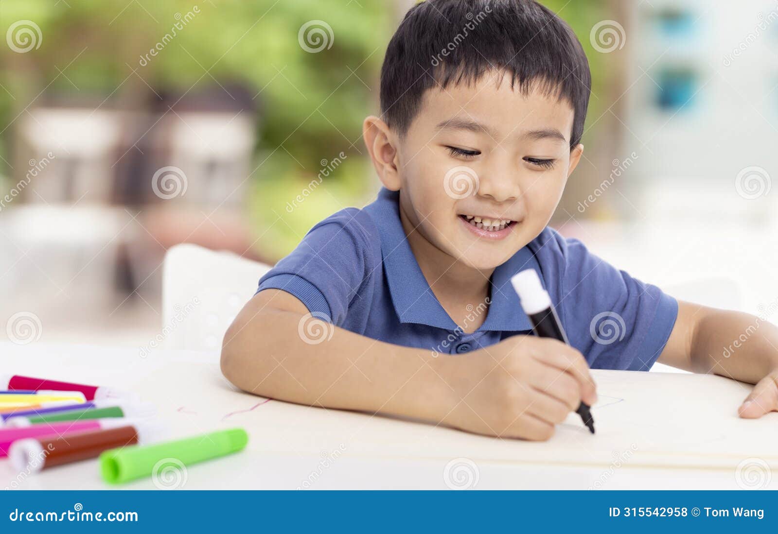 Smiling Asian Child Schoolboy Studying and Writing at Home Stock Photo ...