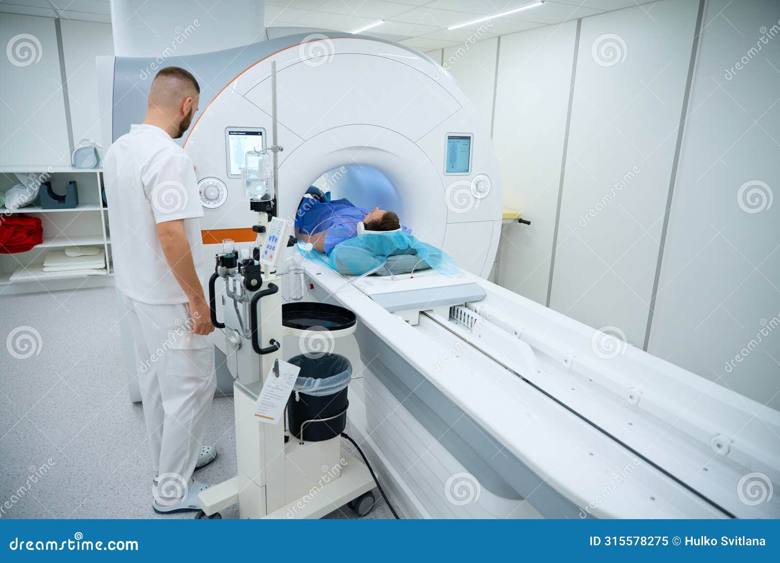 Doctor Preparing Man for Knee Magnetic Resonance Imaging Procedure ...