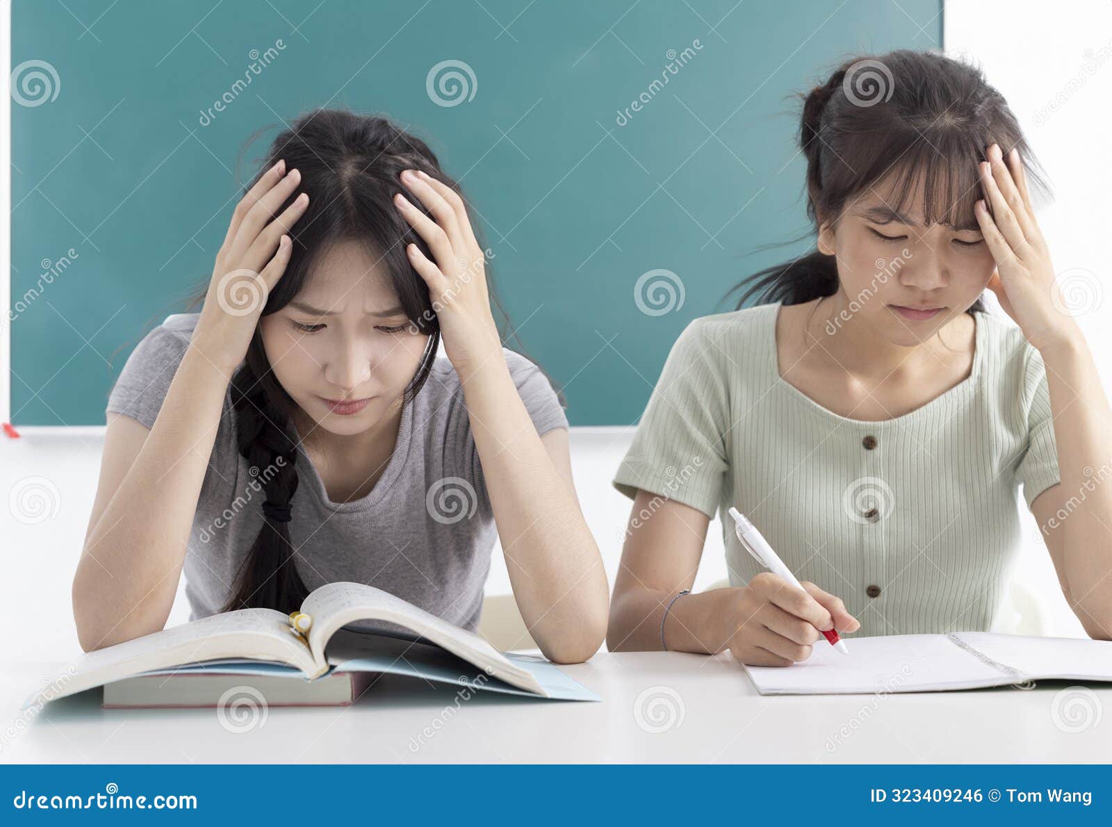 Tired Upset Student Girls Grabbing Head in Classroom Stock Photo ...