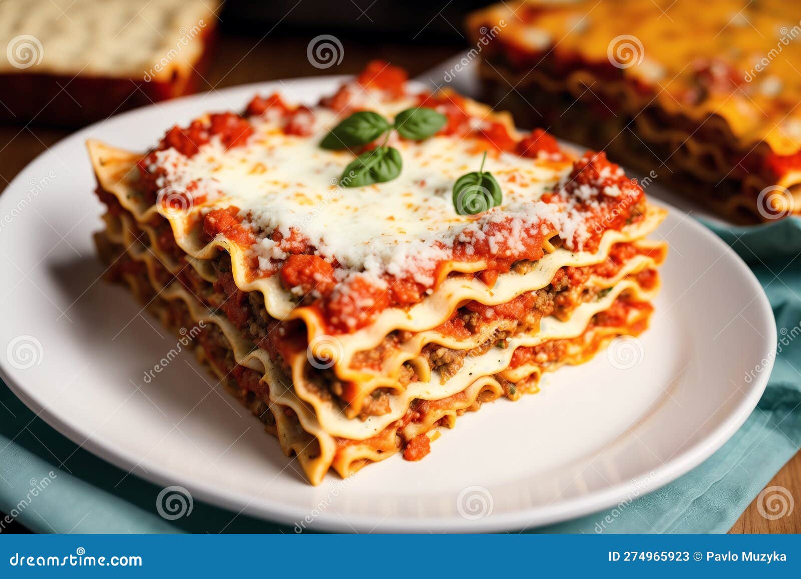 A Stack of Lasagna with a Slice of Lasagna on Top on a Wooden Table ...