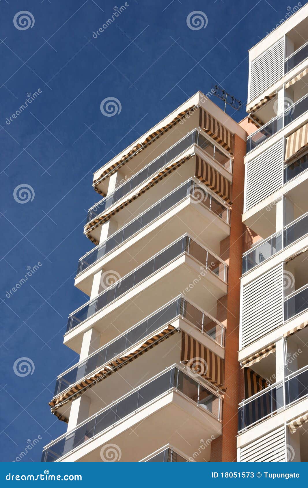 Generic Apartment Building Upper Level Against Trees With Blue Sky And ...