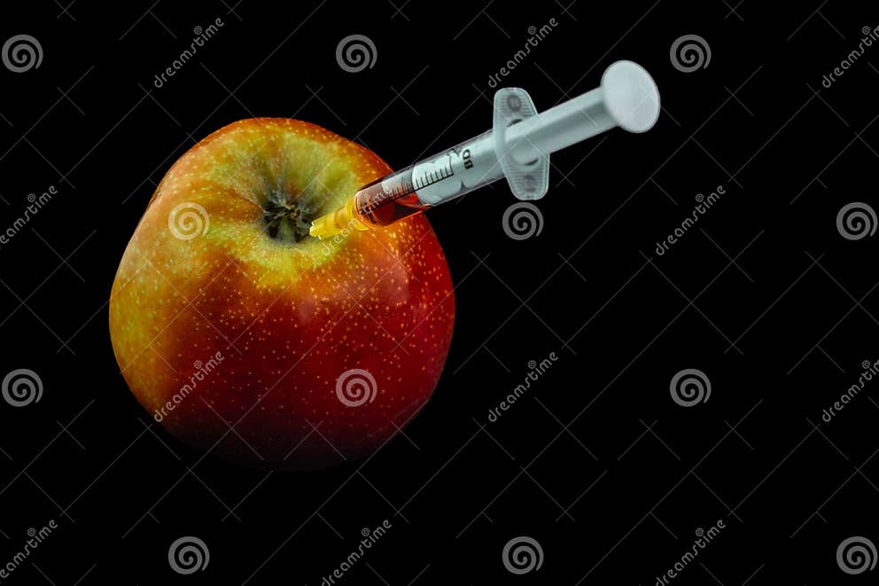 Genetically Modified Apple on a Black Background, a Syringe Stuck into ...