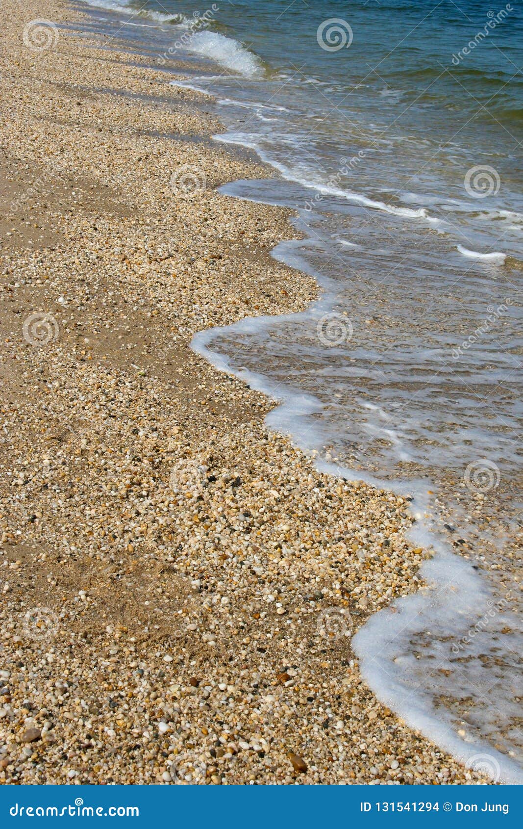 Gentle Waves Lapping on a Pebble Sand Beach Stock Photo - Image of angle, coast: 131541294