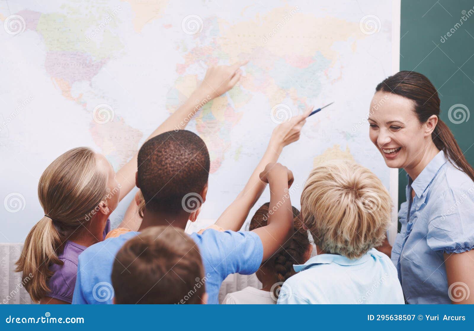Geography Can Be Fun. a Group of Children Looking at a World Map during ...